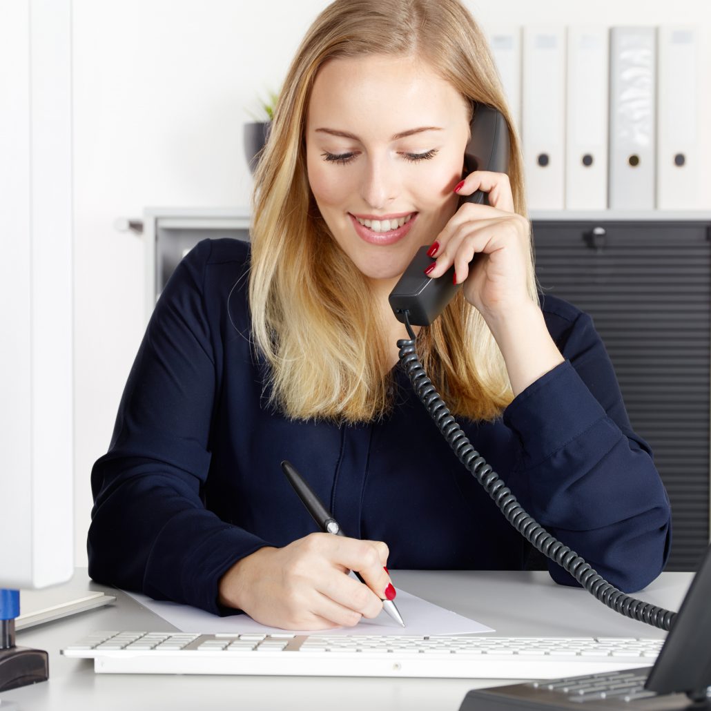 Female office assistant has a call at the office - Quevilly Habitat